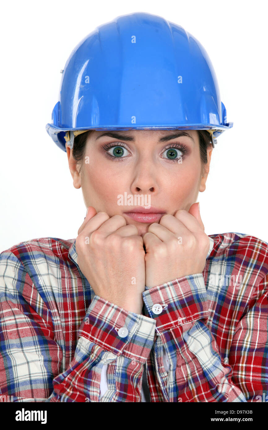 Scared female construction worker Stock Photo - Alamy