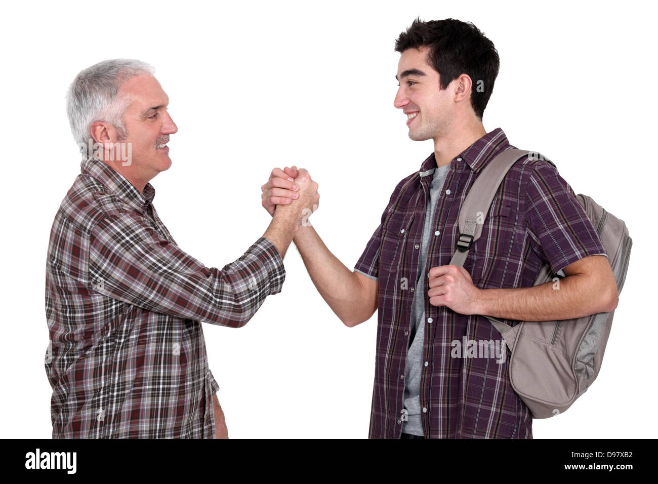 Mature man and young man handshaking Stock Photo - Alamy