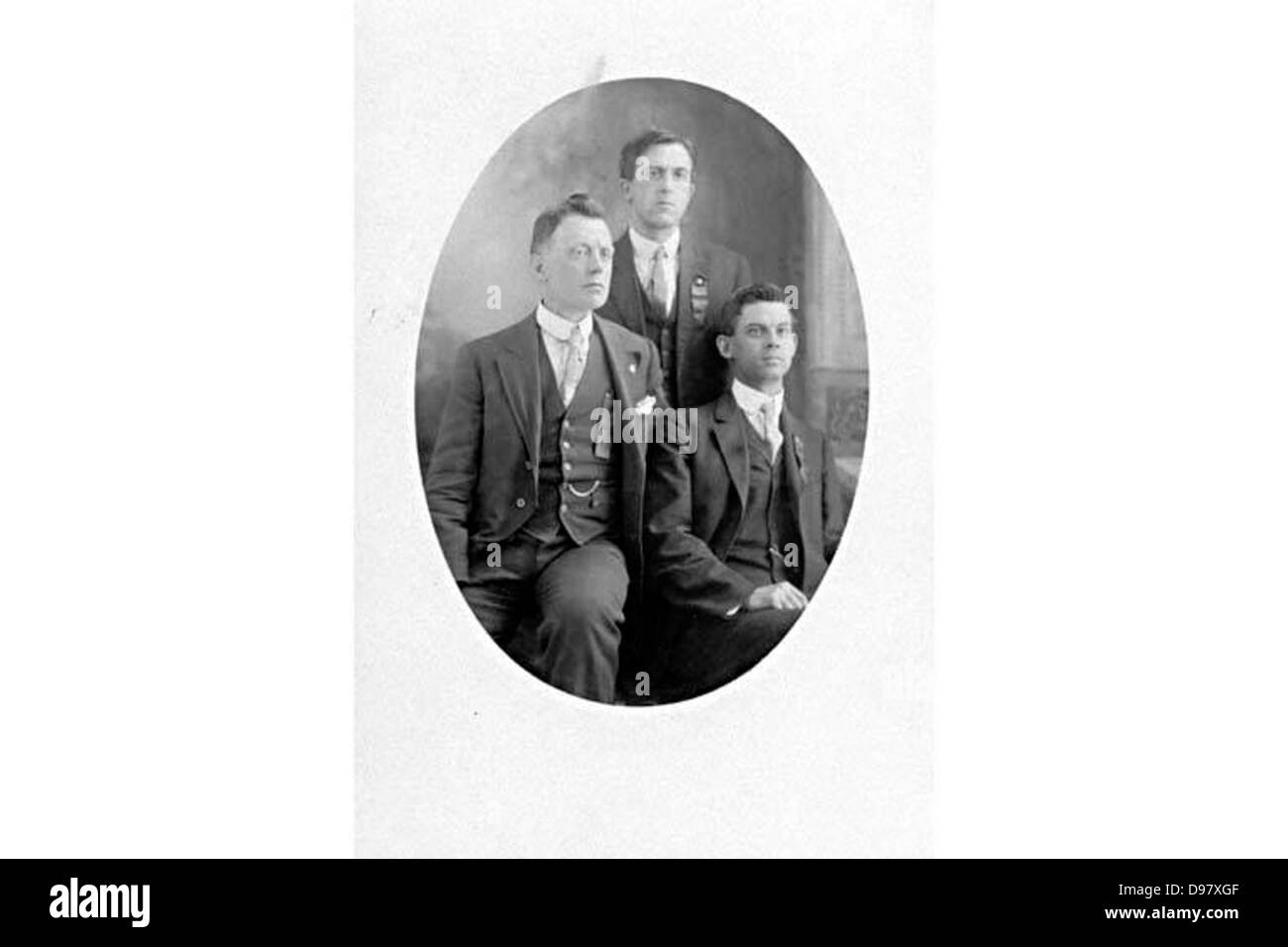 This photographic postcard features three members of the Industrial ...