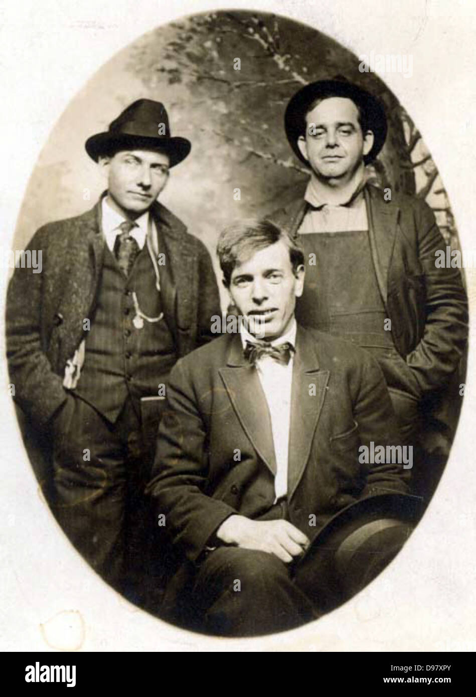 This photographic postcard shows three members of the Industrial ...