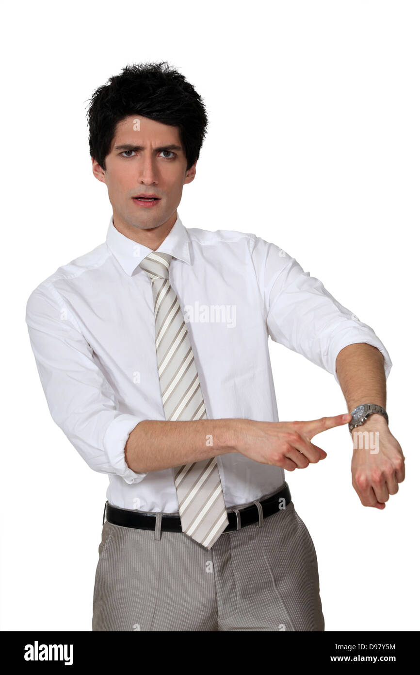 Businessman pointing to his watch Stock Photo - Alamy