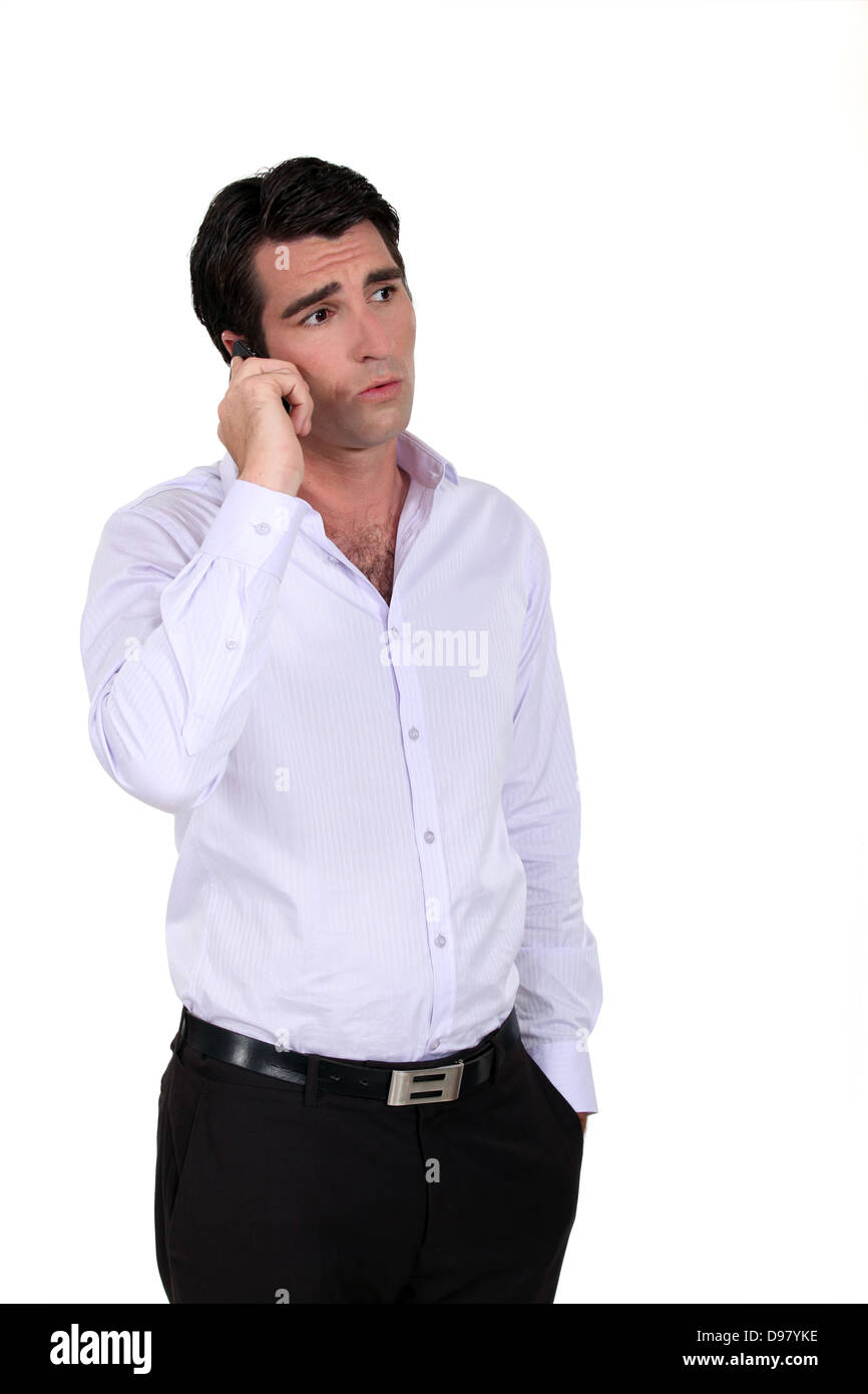 Concerned businessman taking phone call Stock Photo - Alamy