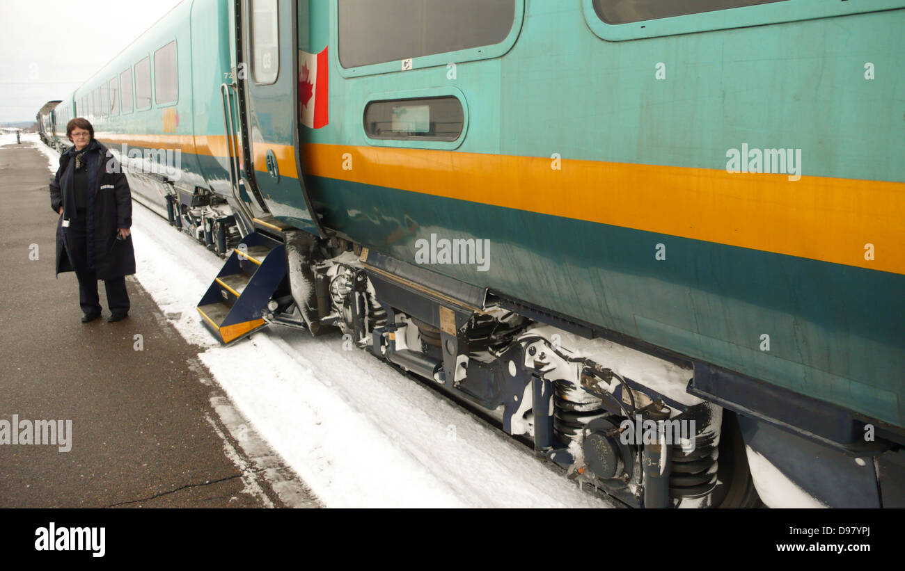A Via Rail conductor checks to make sure everyone is on board the ...