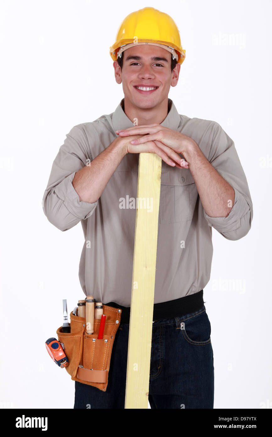 Young builder with a piece of timber Stock Photo - Alamy
