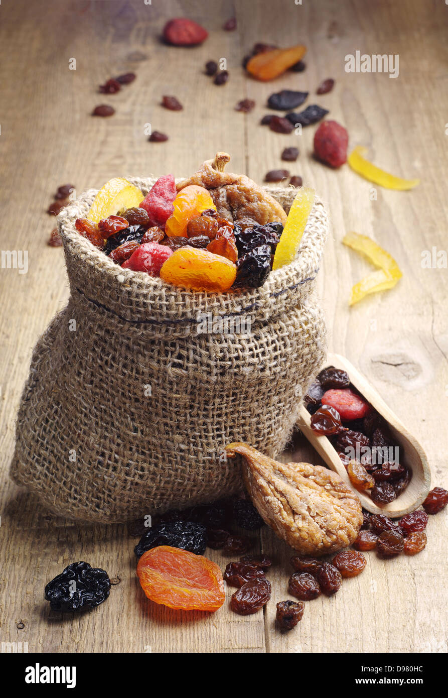Dried fruits in a sack and spoon on the wooden table Stock Photo - Alamy