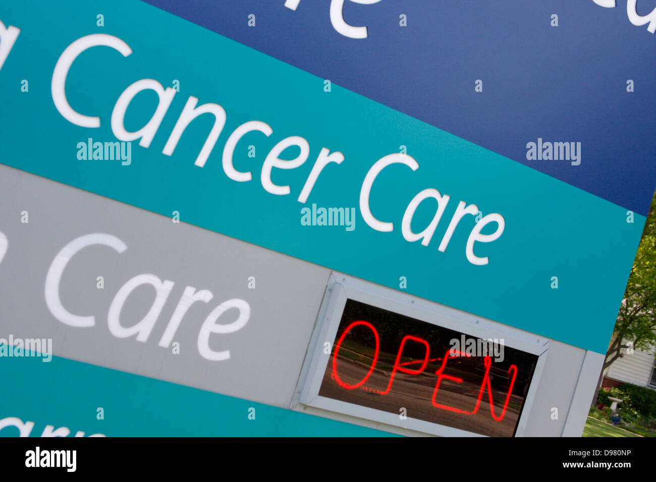 A clinic with cancer and walk in care has a open sign Stock Photo - Alamy
