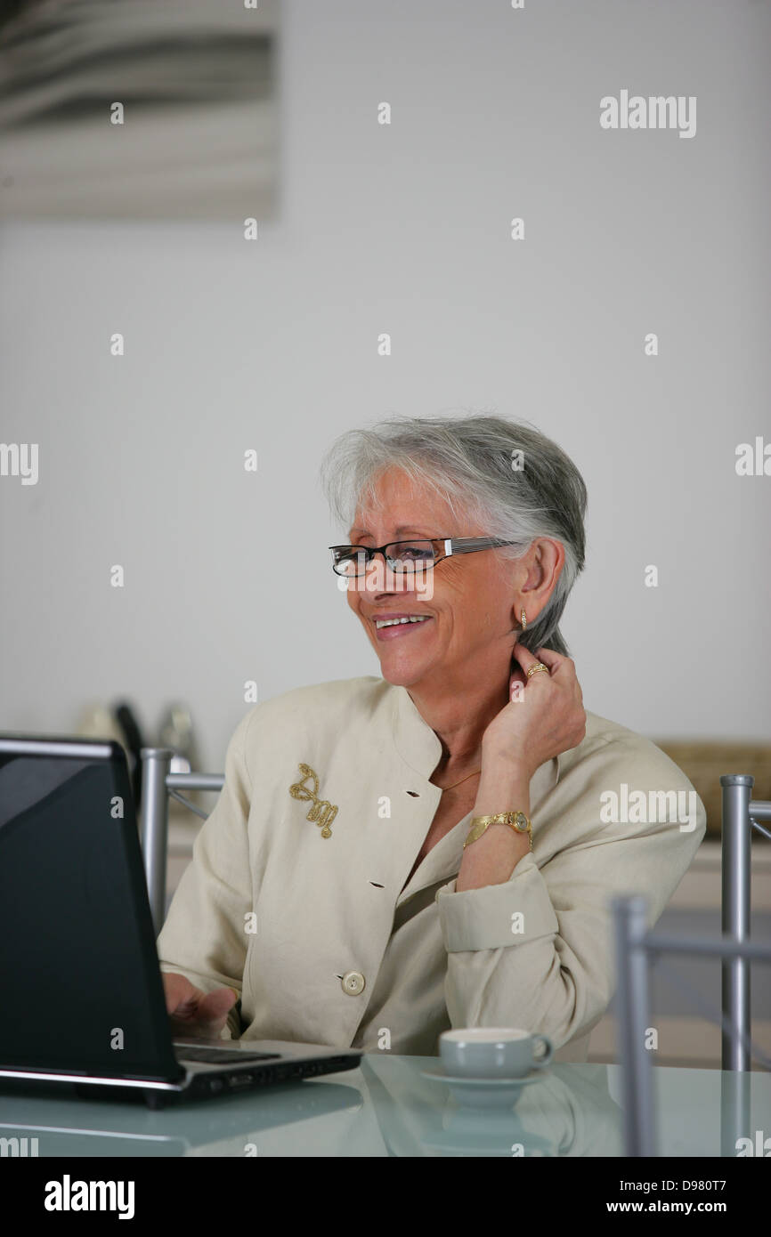 Old lady laughing laptop hi-res stock photography and images - Alamy