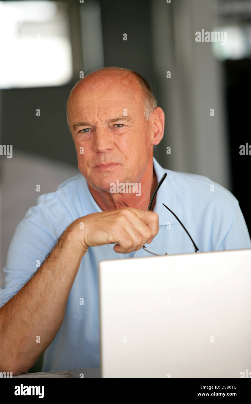 Elderly man using a laptop Stock Photo - Alamy