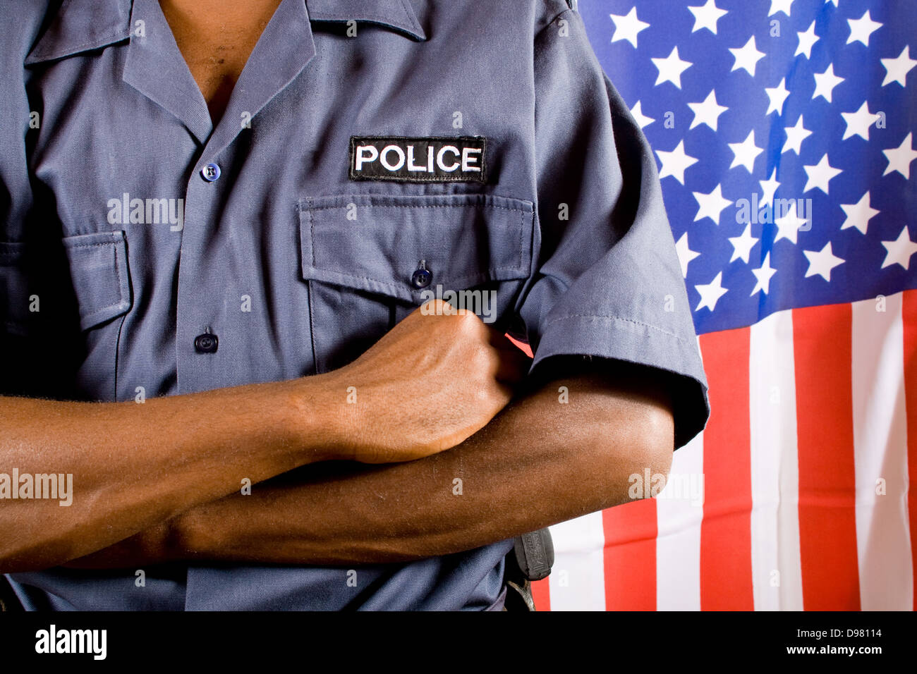 African American policeman standing in front of USA flag Stock Photo ...
