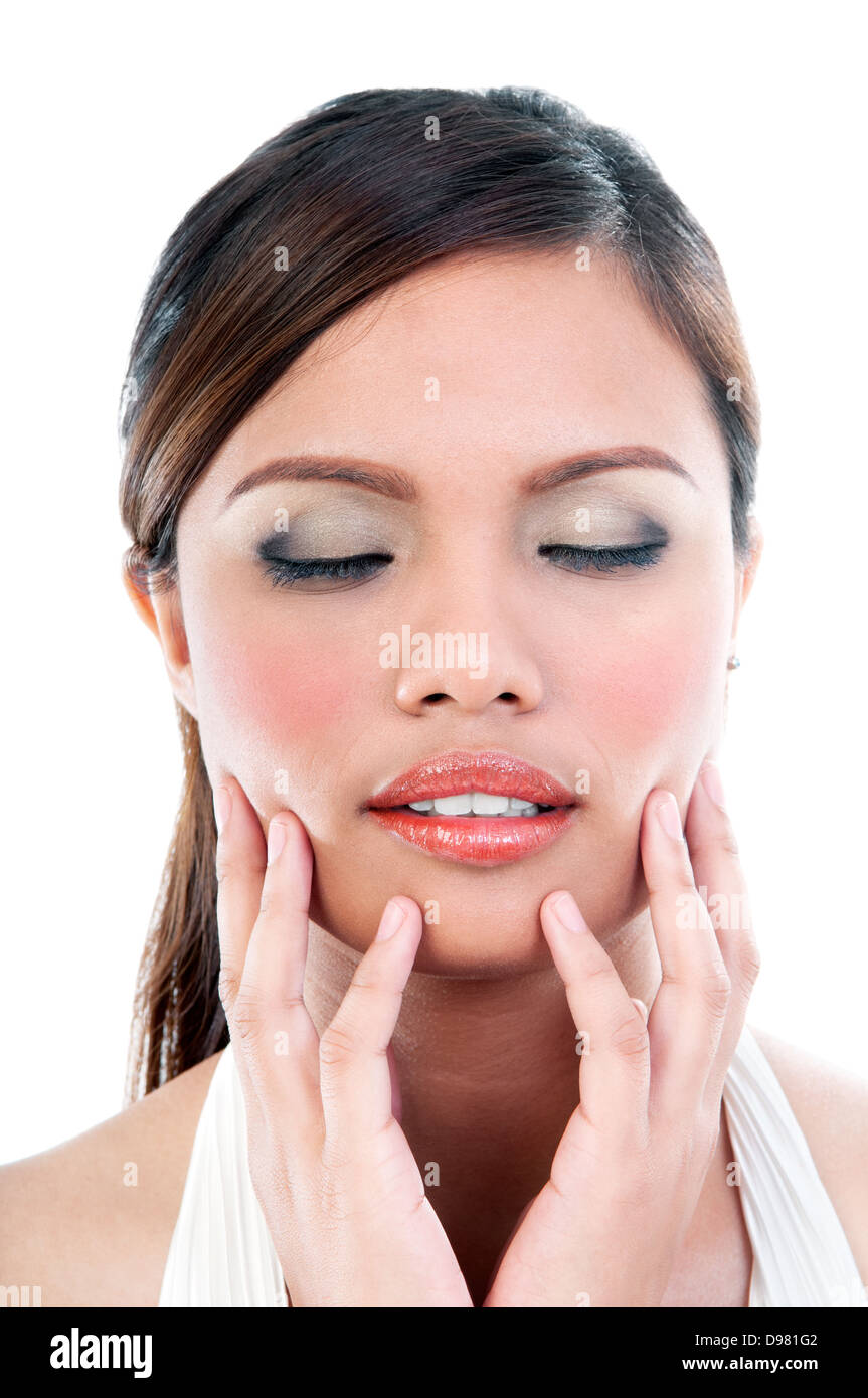 Young woman with eyes closed and hands on face, closeup Stock Photo - Alamy