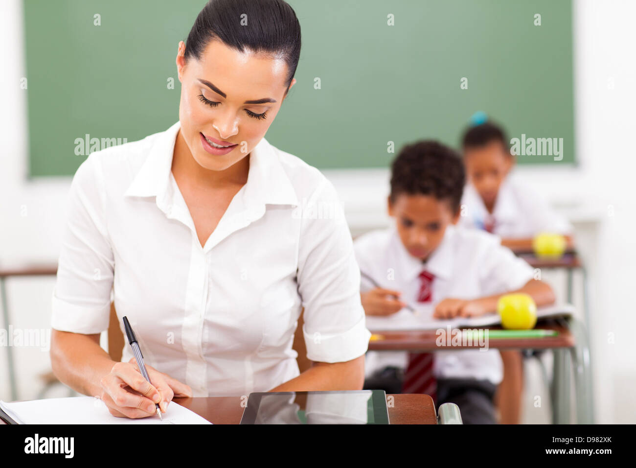 elegant female school teacher preparing lessons in classroom Stock ...