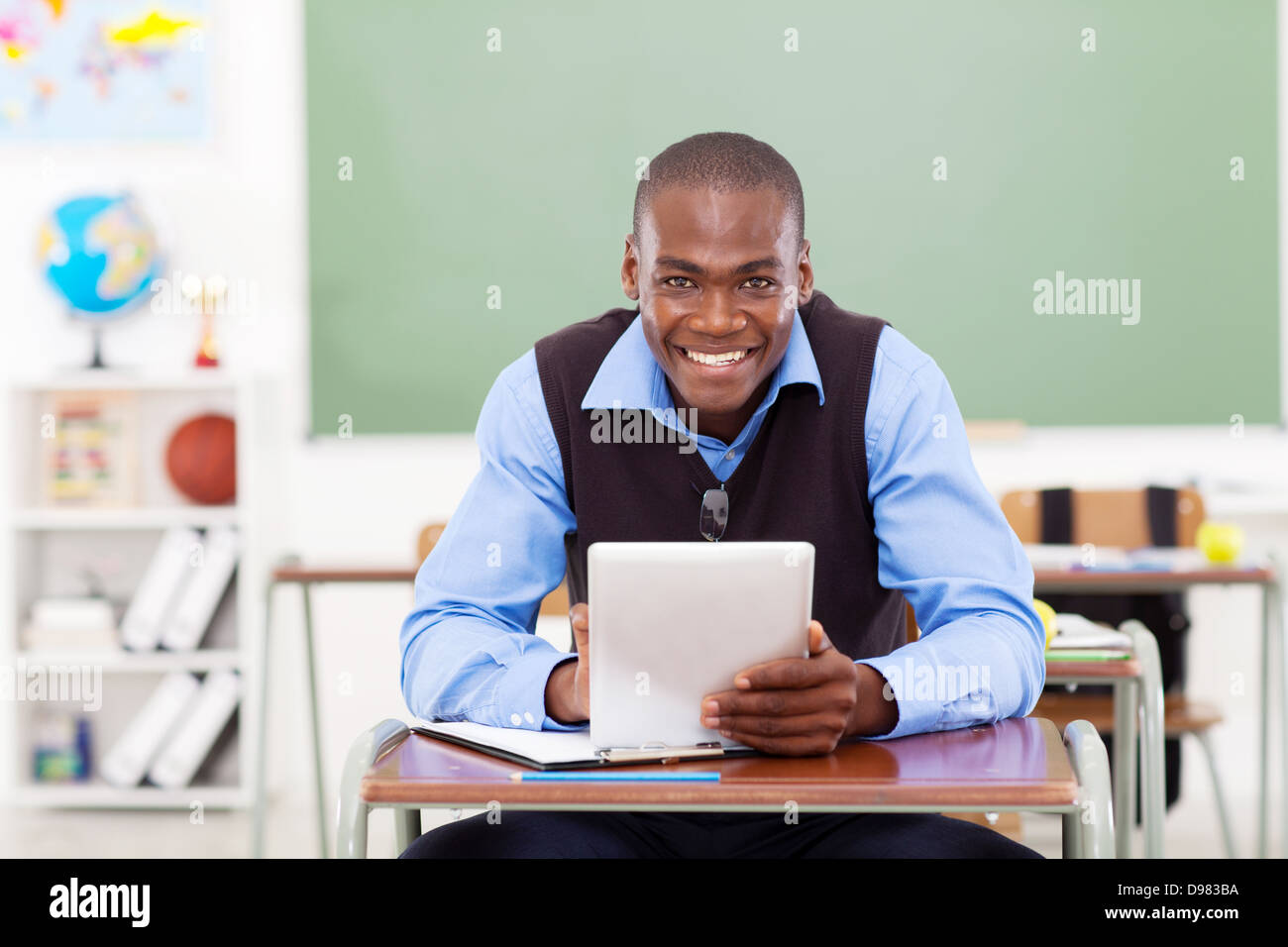 handsome elementary school teacher using a tablet computer Stock Photo ...
