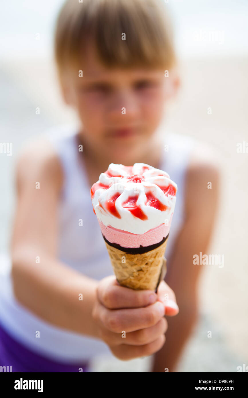 Closeup of ice cream held in hand by cute young girl Stock Photo - Alamy