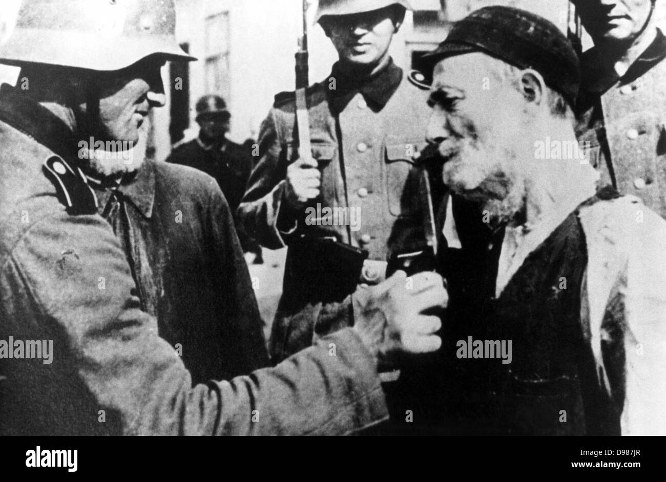 German soldiers cutting the beard of an elderly Polish Jew during the ...