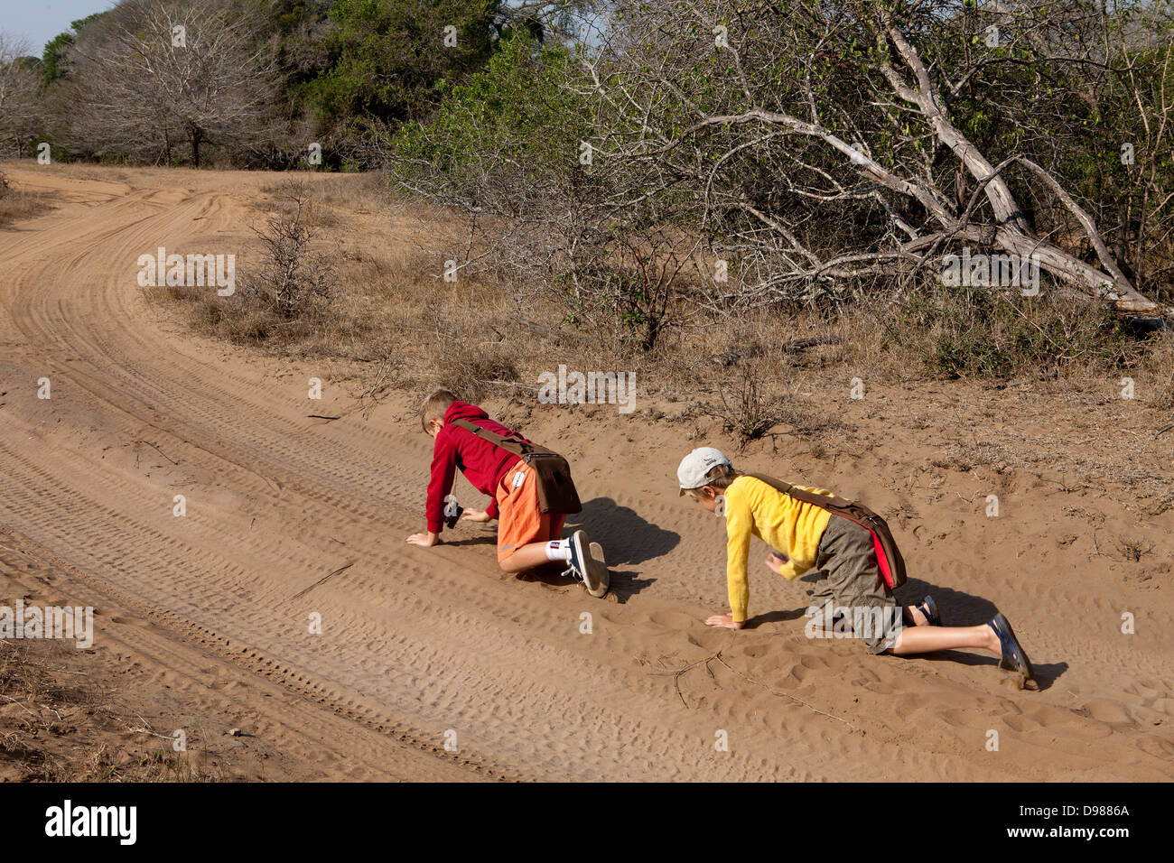 Robin Tetlow Shooter & Tyler Talmage studying game tracks on the sand ...