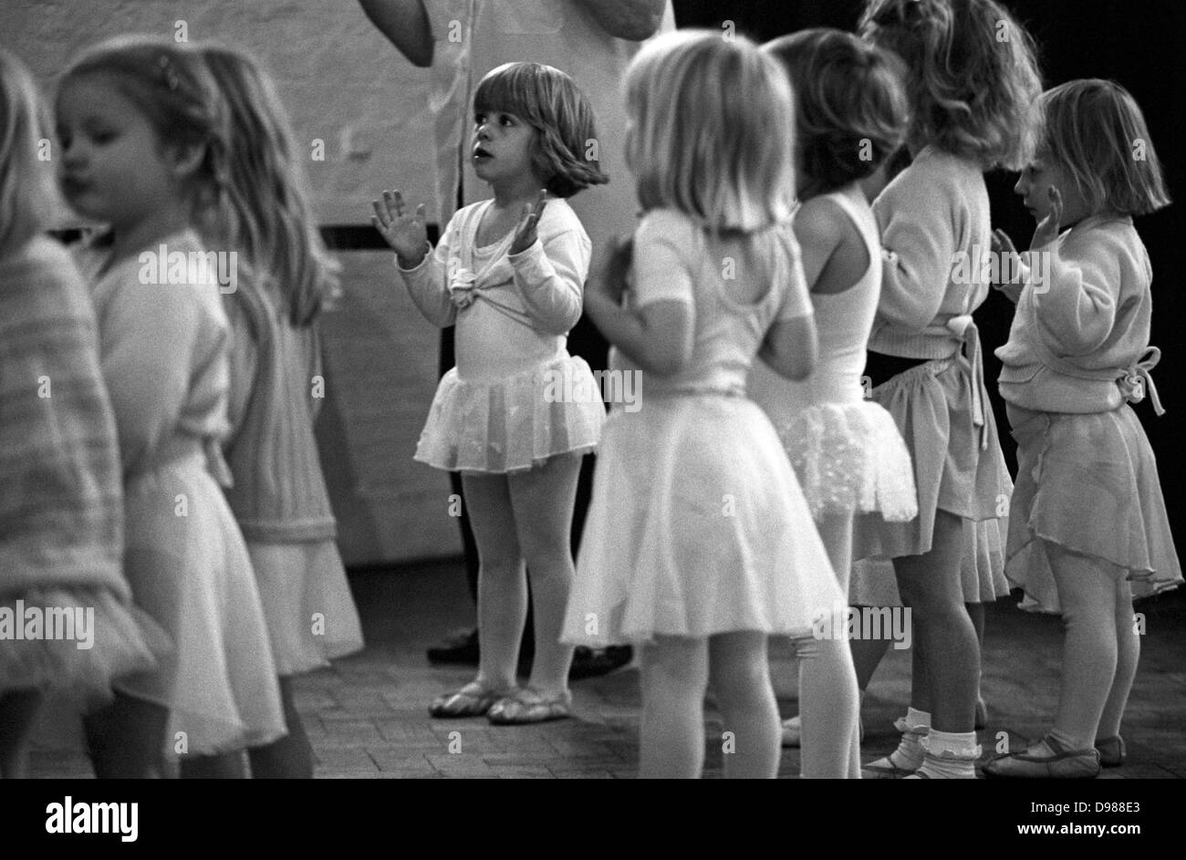 Three and four year-old girls clap their hands during a Saturday ...
