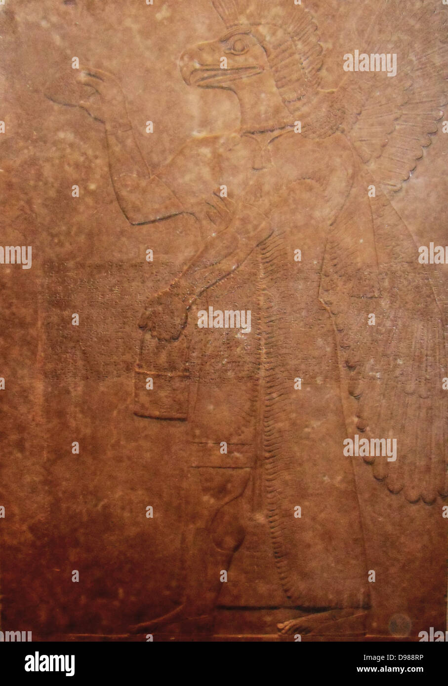 Assyrian winged genie figure depicted in a relief from the Noth West ...