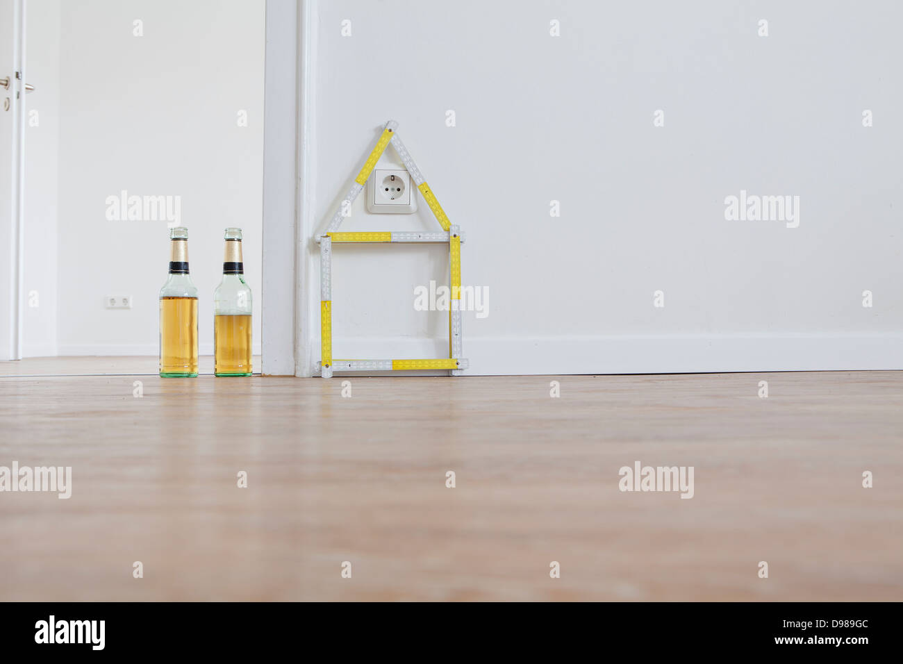 Folded ruler in house shape with beer bottle Stock Photo - Alamy