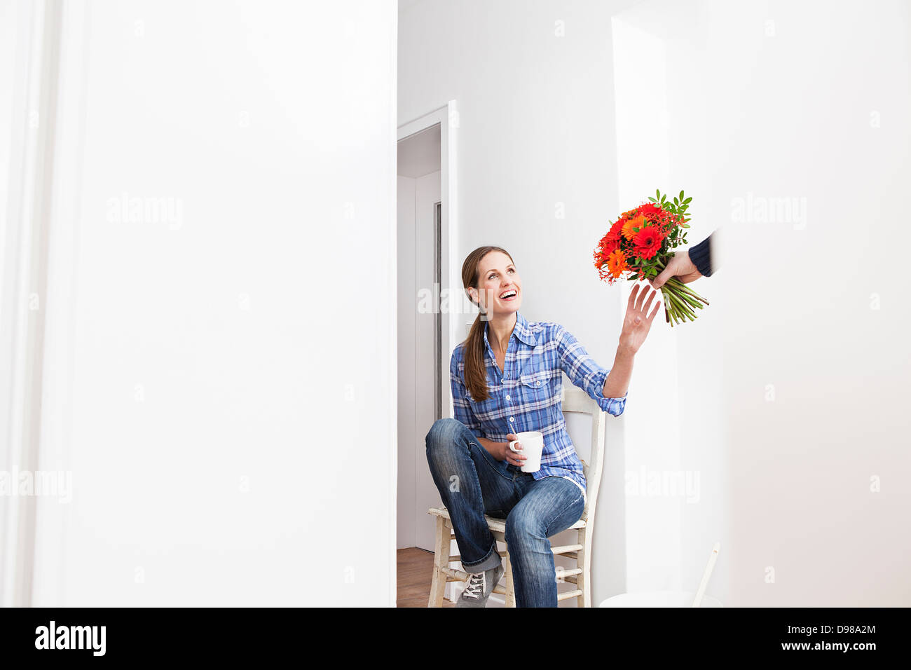Human hand giving bunch of flowers to woman, smiling Stock Photo - Alamy