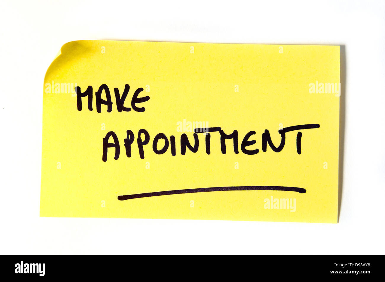 Make appointment written in capital letters on a yellow post-it note ...