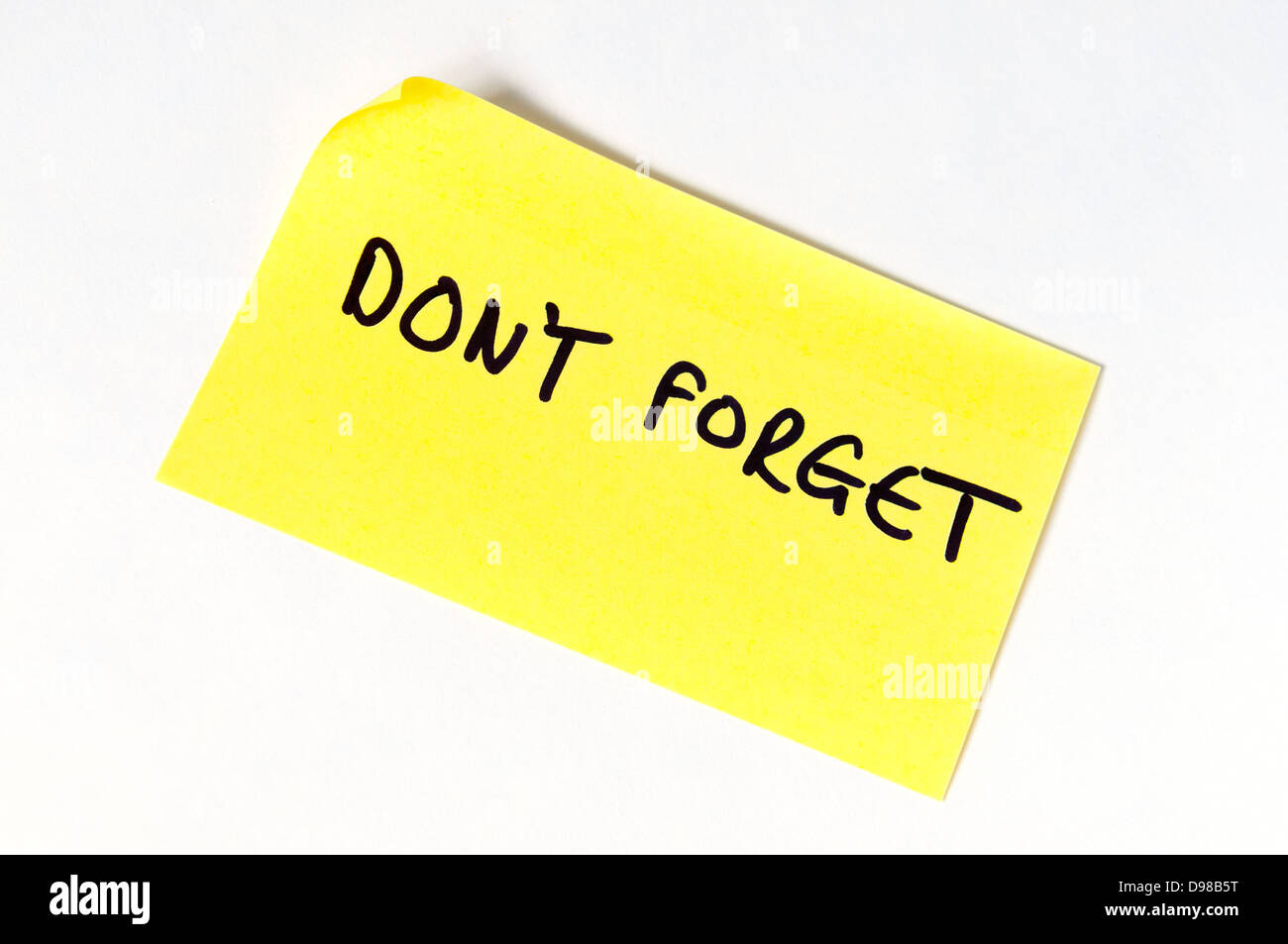 Don't Forget written in capital letters on a yellow post it note Stock ...