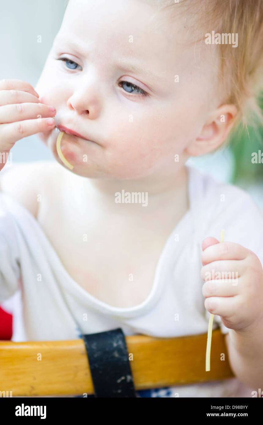 Baby girl eating spaghetti hi-res stock photography and images - Alamy
