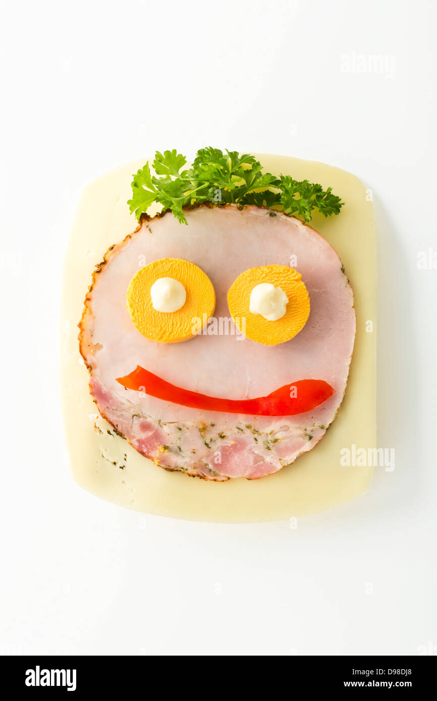 Smiley sausage sandwich with cheese and pepper on white background ...