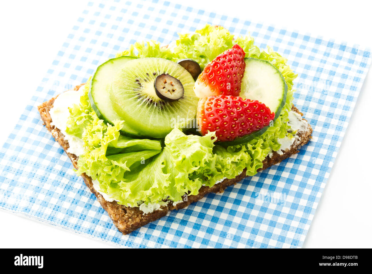 Fitness sandwich with cream cheese, lettuce and slices of fruits on ...