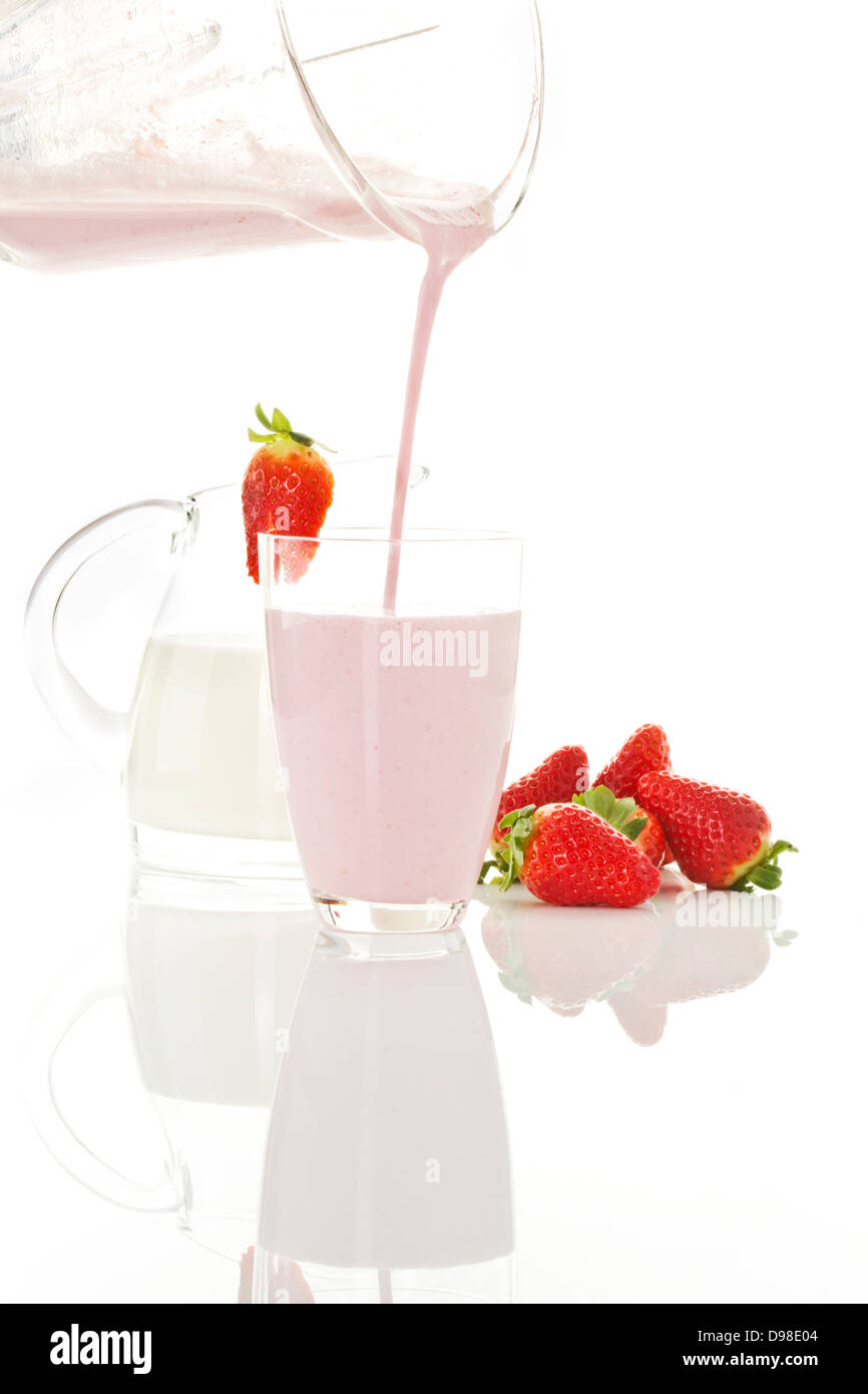 Pouring strawberry milk shake in glass, close up Stock Photo - Alamy