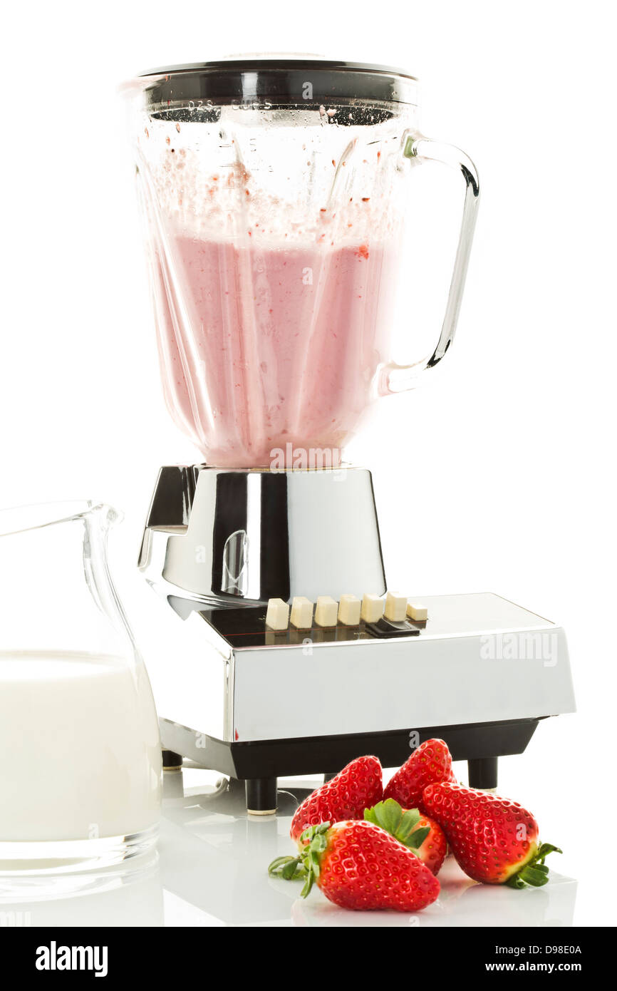 Blending strawberry milk shake on white background, close up Stock ...