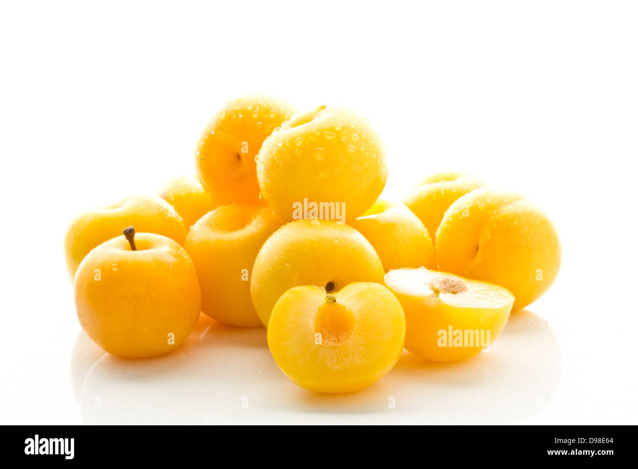 Yellow plums on white background, close up Stock Photo - Alamy