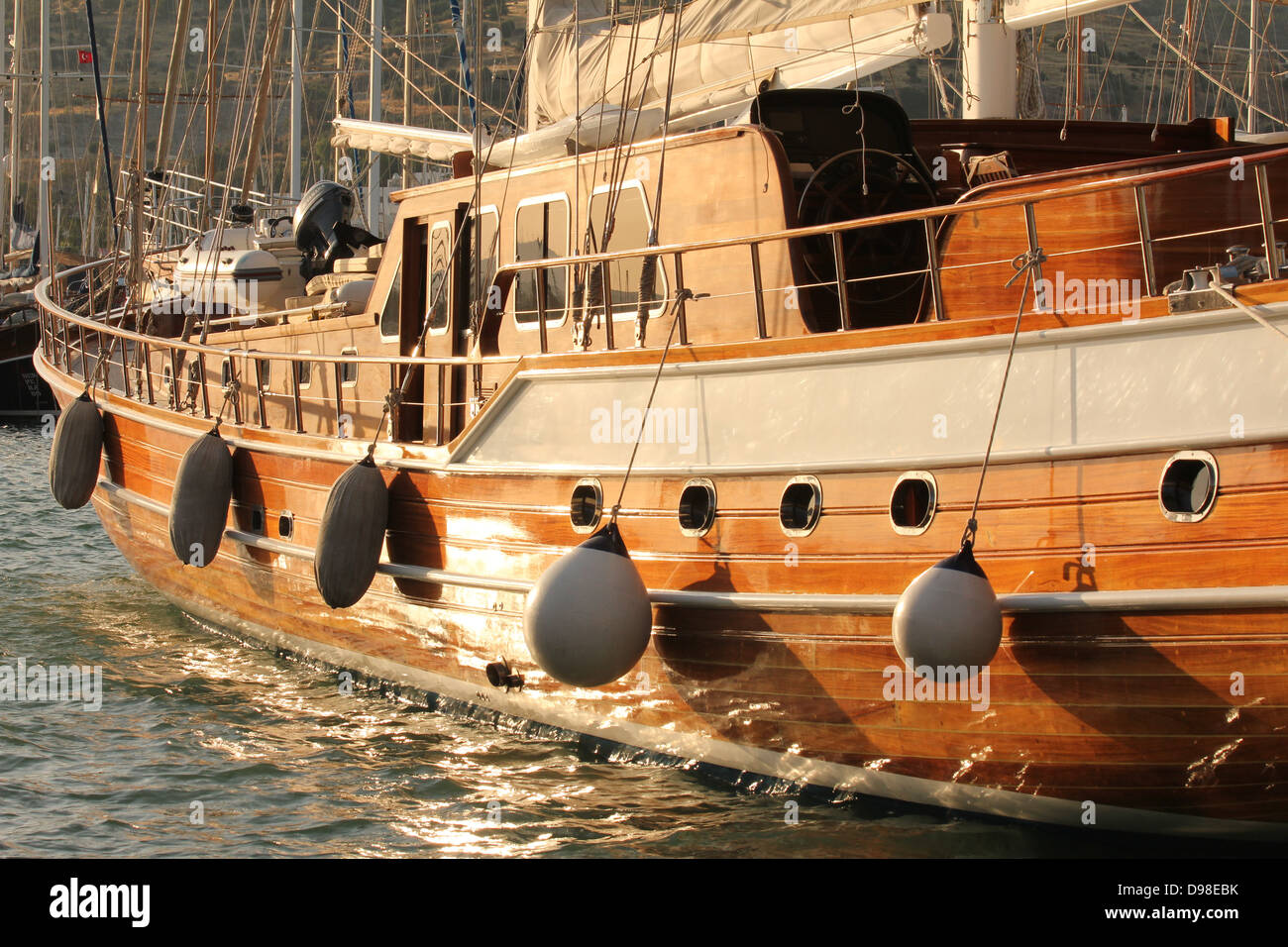 Wooden hull sailing boat at anchor in Bodrum Harbour, Turkey with water ...