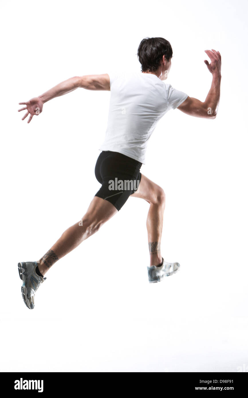 Young man running on white background Stock Photo - Alamy