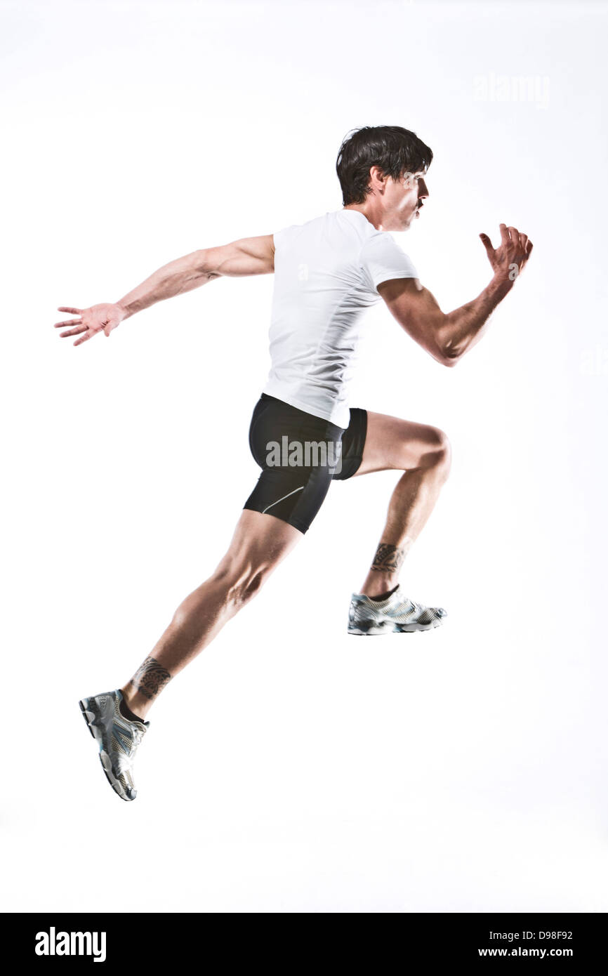 Young man running on white background Stock Photo - Alamy