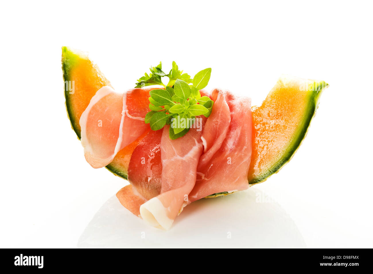 Slice of sugar melon with ham on white background, close up Stock Photo ...