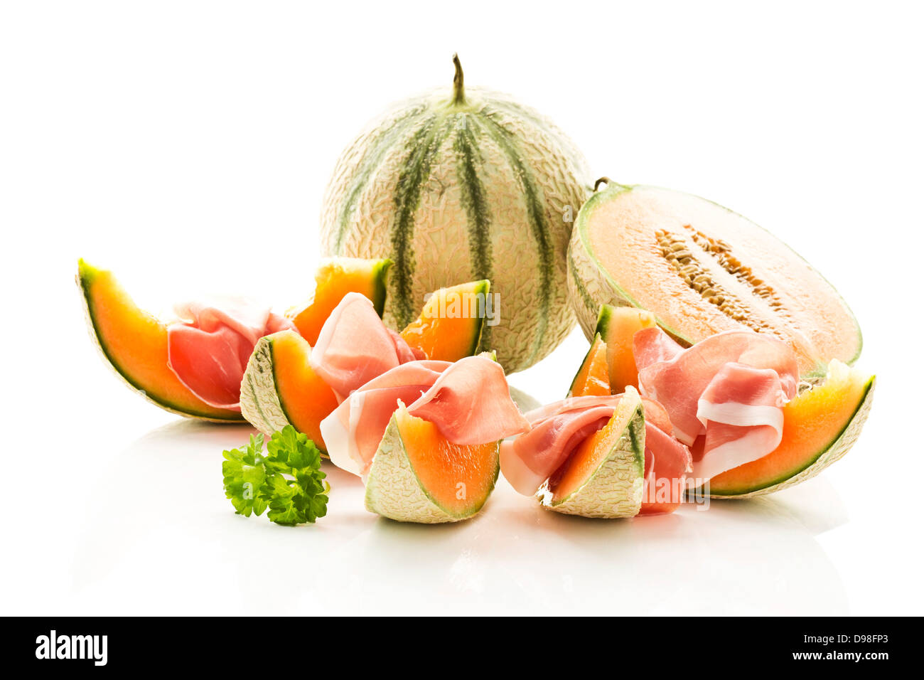 Sugar melons with ham on white background, close up Stock Photo - Alamy