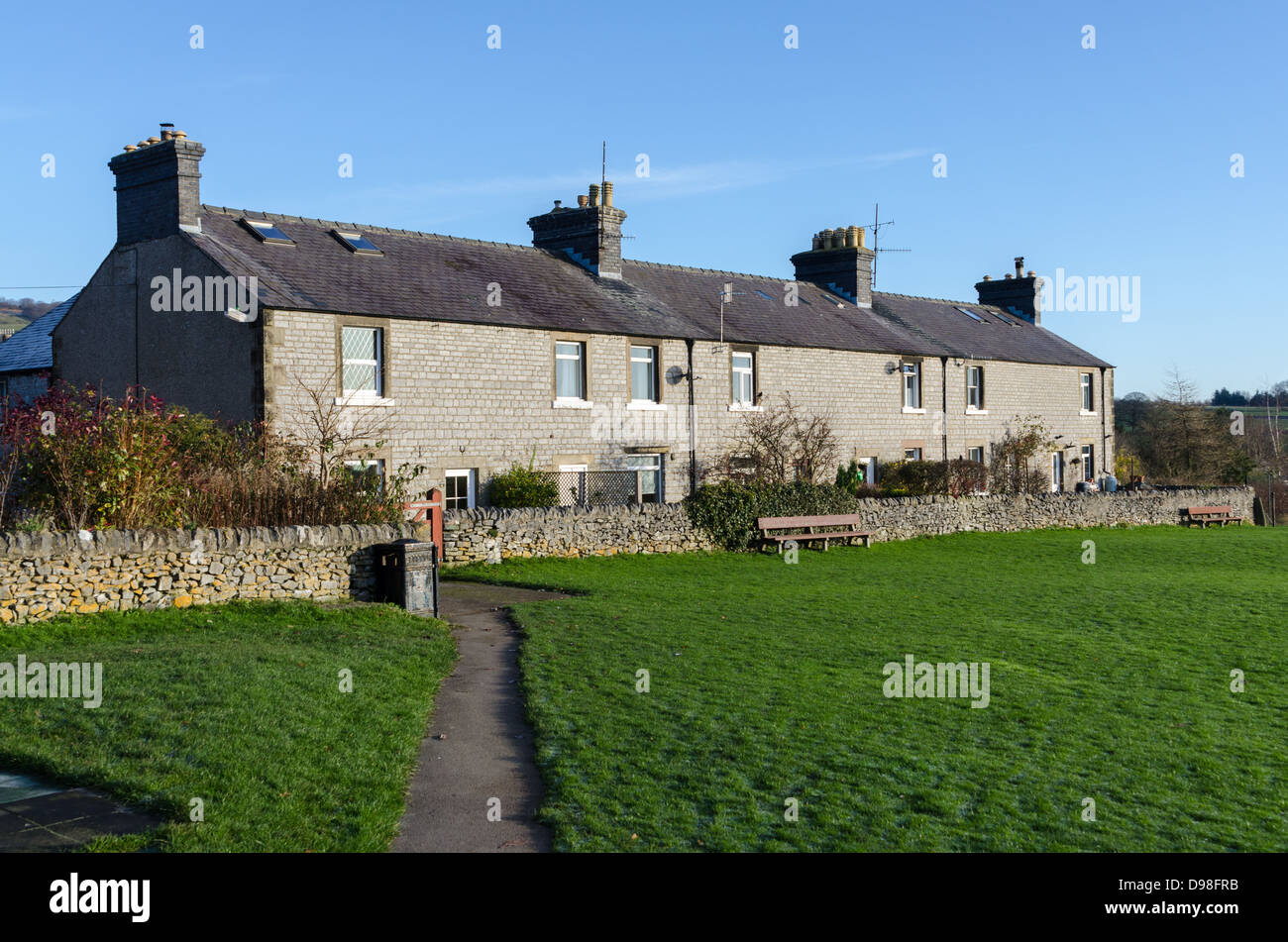 Traditional stone cottages over looking playing fields in the pretty ...