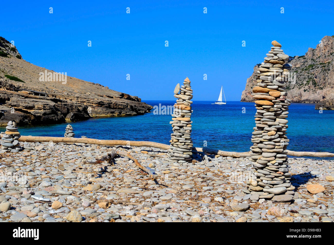 Spain, Bay with stack of stones and sailing ship Stock Photo - Alamy