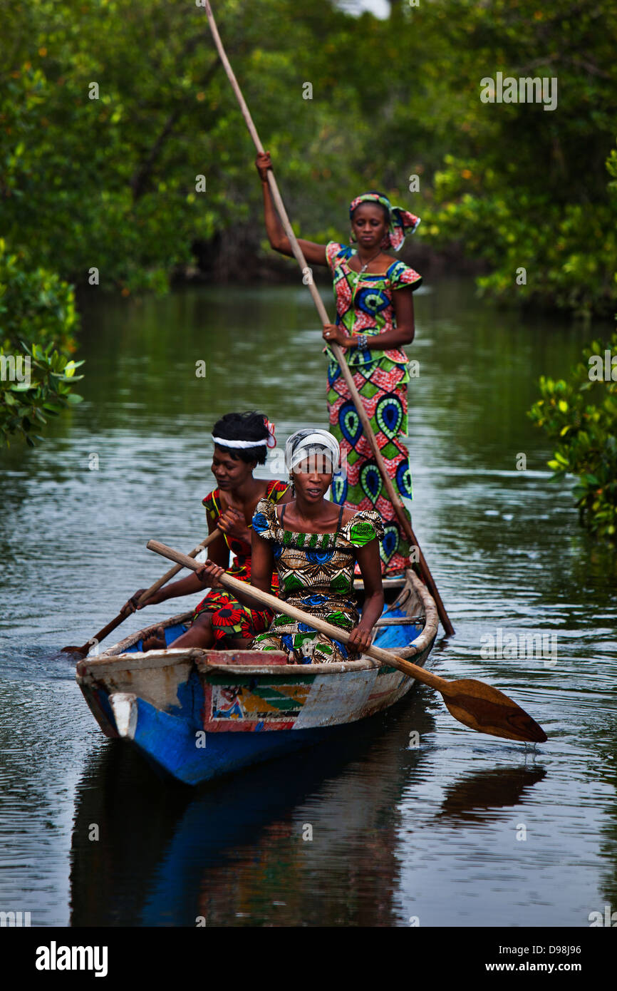 People from the village of Falia rowing traditional pirogue through the ...