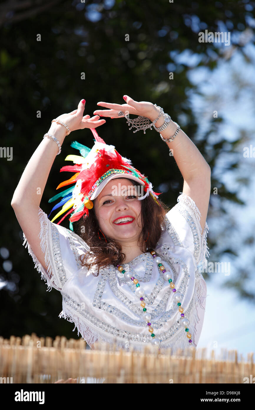 Smiling woman dancing on a float in carnaval parade at Mission District ...