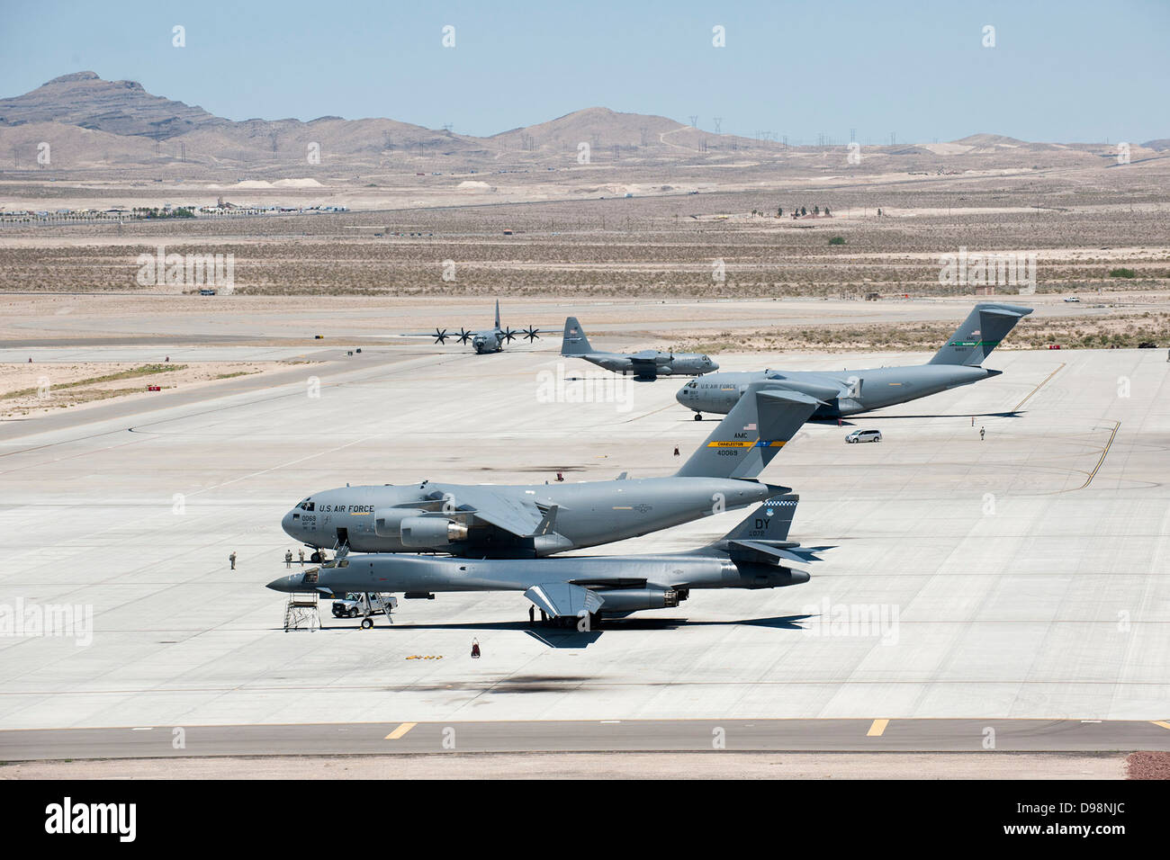 Several C-17 Globemaster IIIs, C-130 Hercules and a B-1 Lancer park on ...