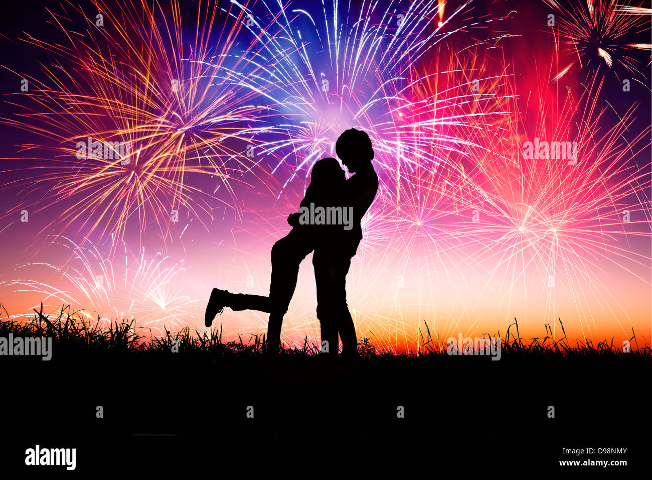 loving young couple with fireworks background Stock Photo - Alamy