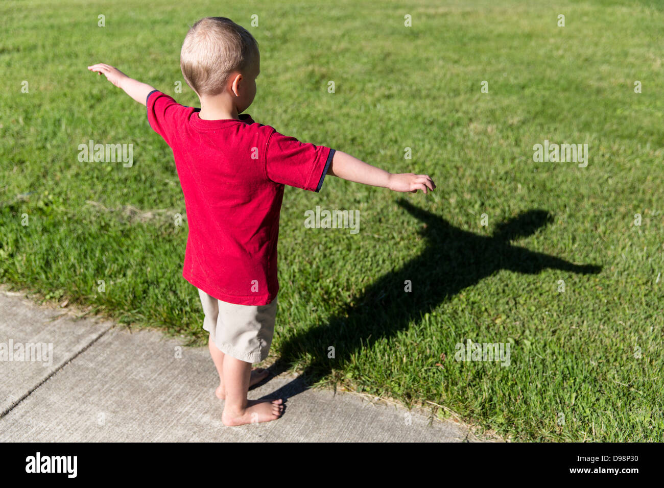 Little boy, age 4, looking at his late afternoon shadow Stock Photo - Alamy