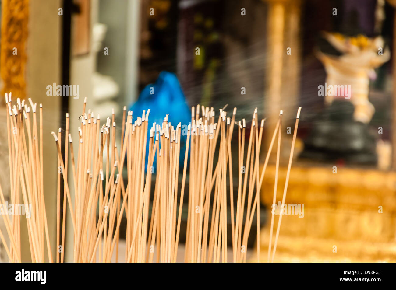 Burning essence sticks outside temple Stock Photo - Alamy