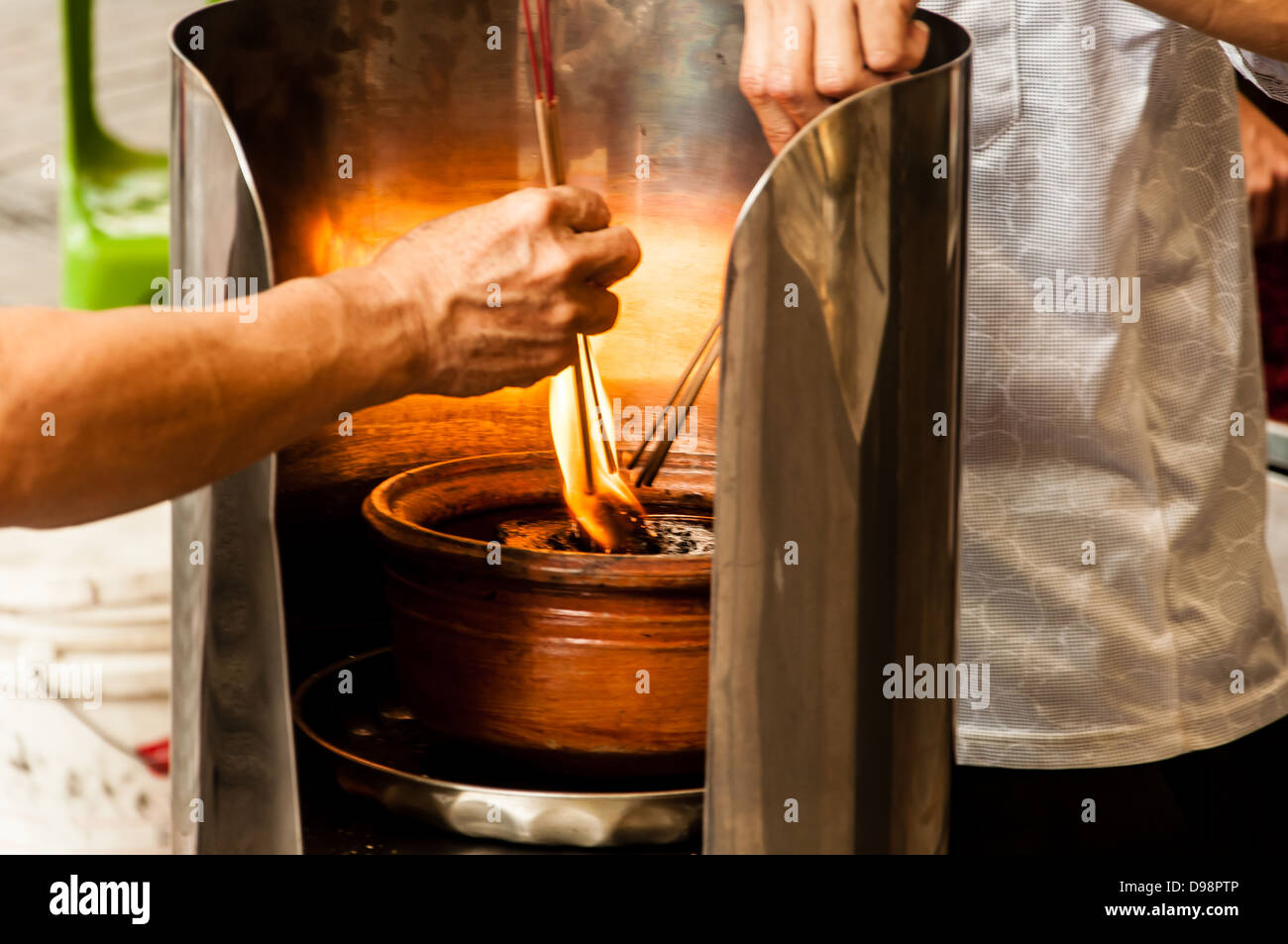 Burning the essence stick outside temple Stock Photo - Alamy
