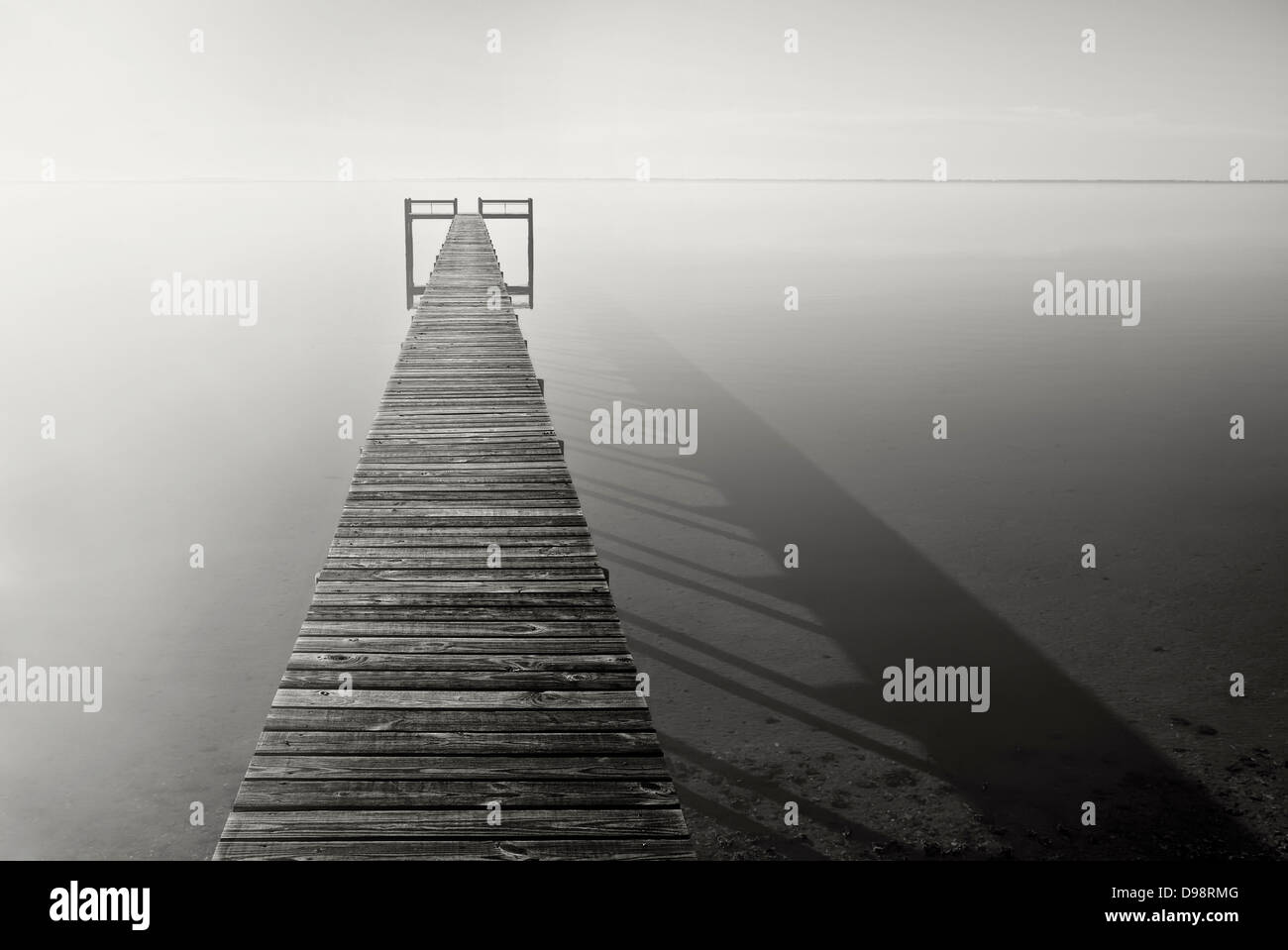Pier extending into the bay, with fog and smoke, Apalachicola, FL Stock ...