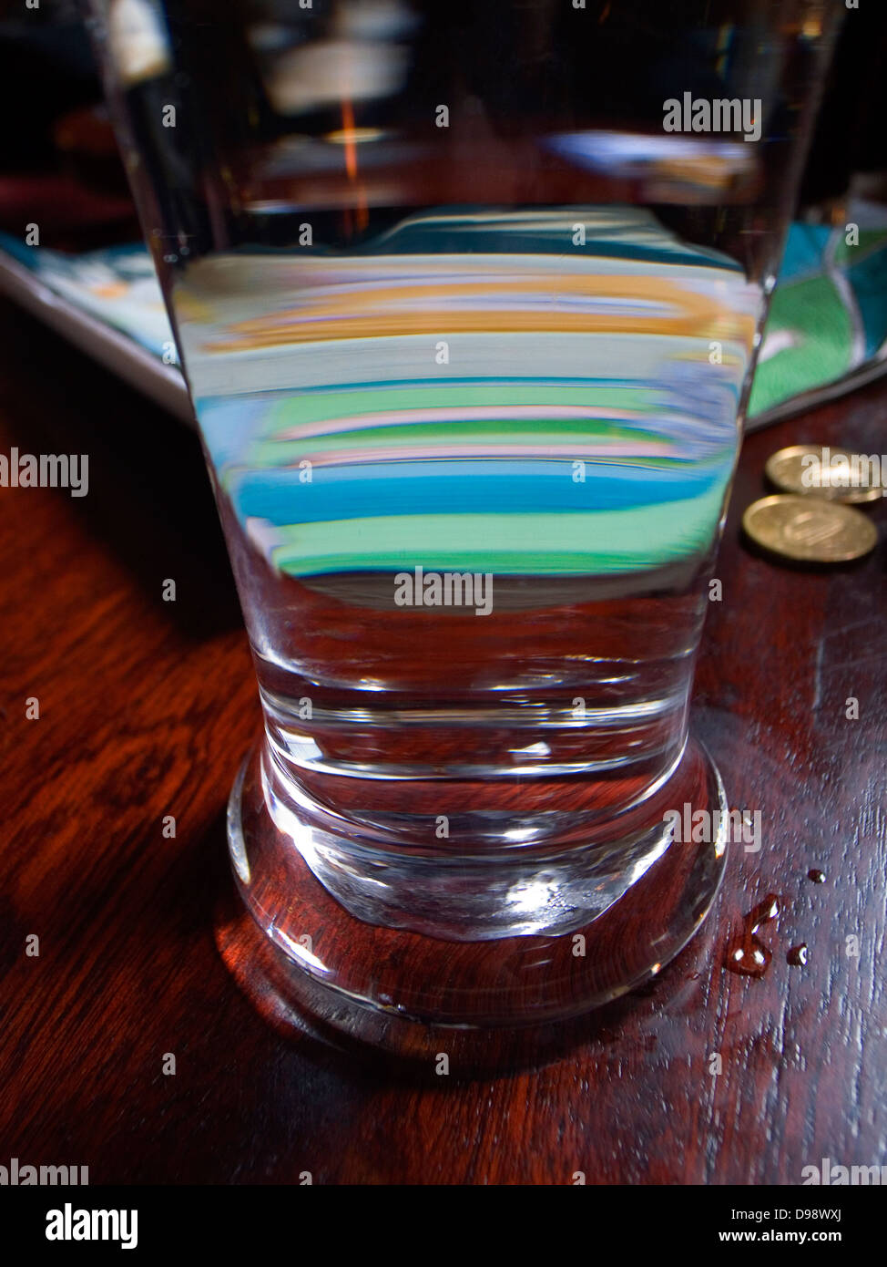 Strange shapes in a glass of water caused by refraction Stock Photo - Alamy