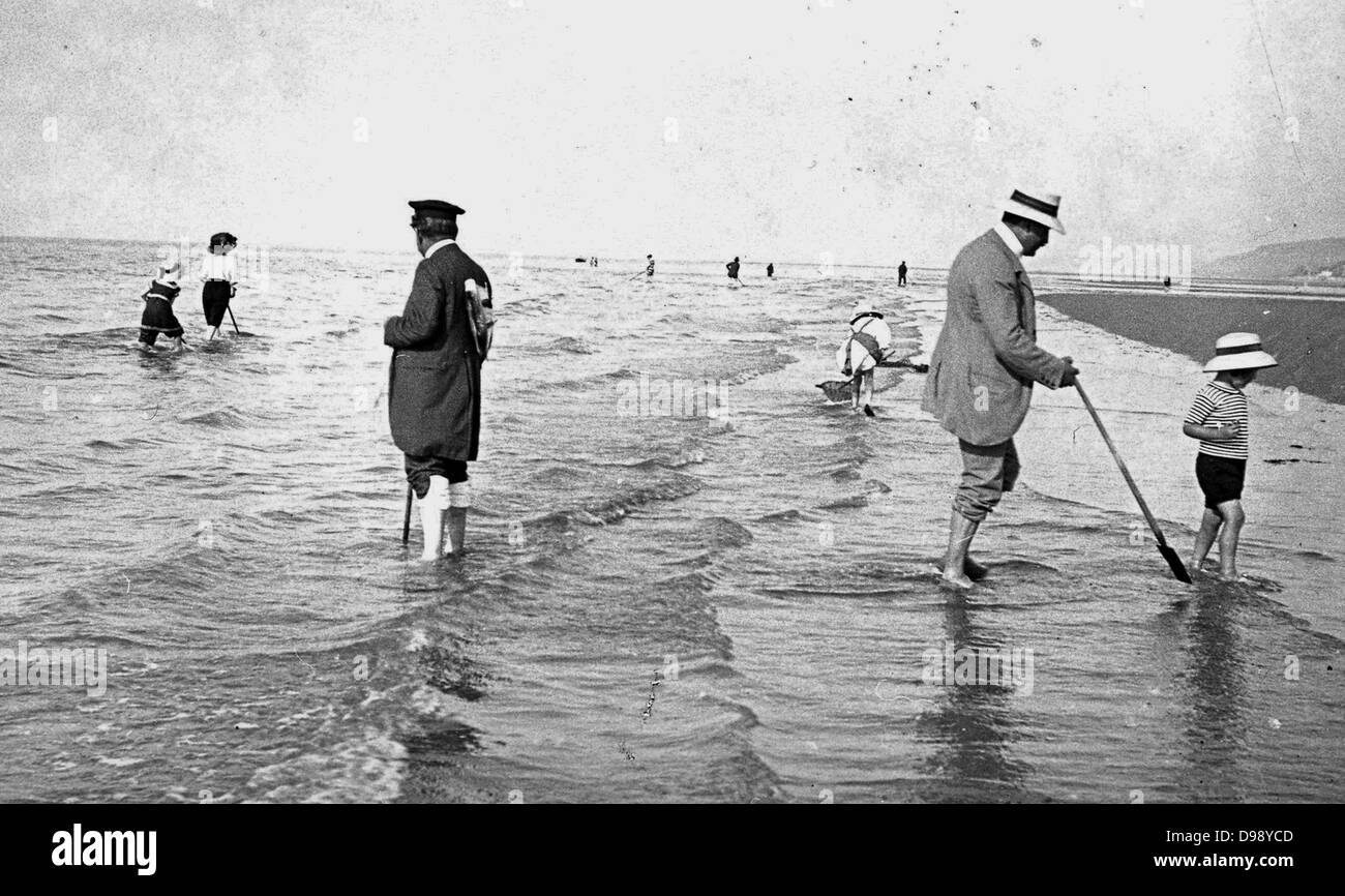 French coastal scene with people on a beach. Circa 1900 Stock Photo - Alamy