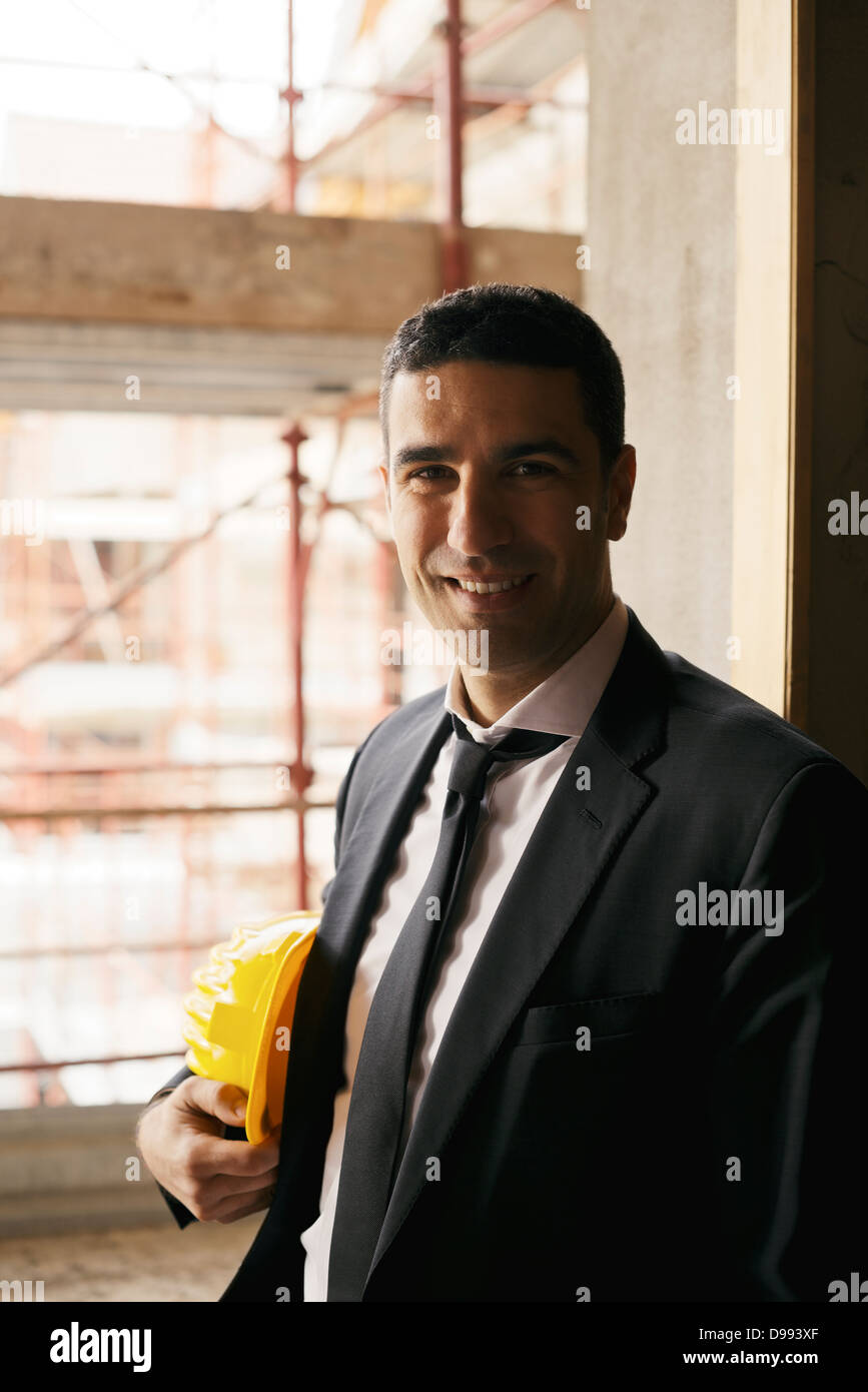 portrait of male engineer smiling and looking at camera in construction ...
