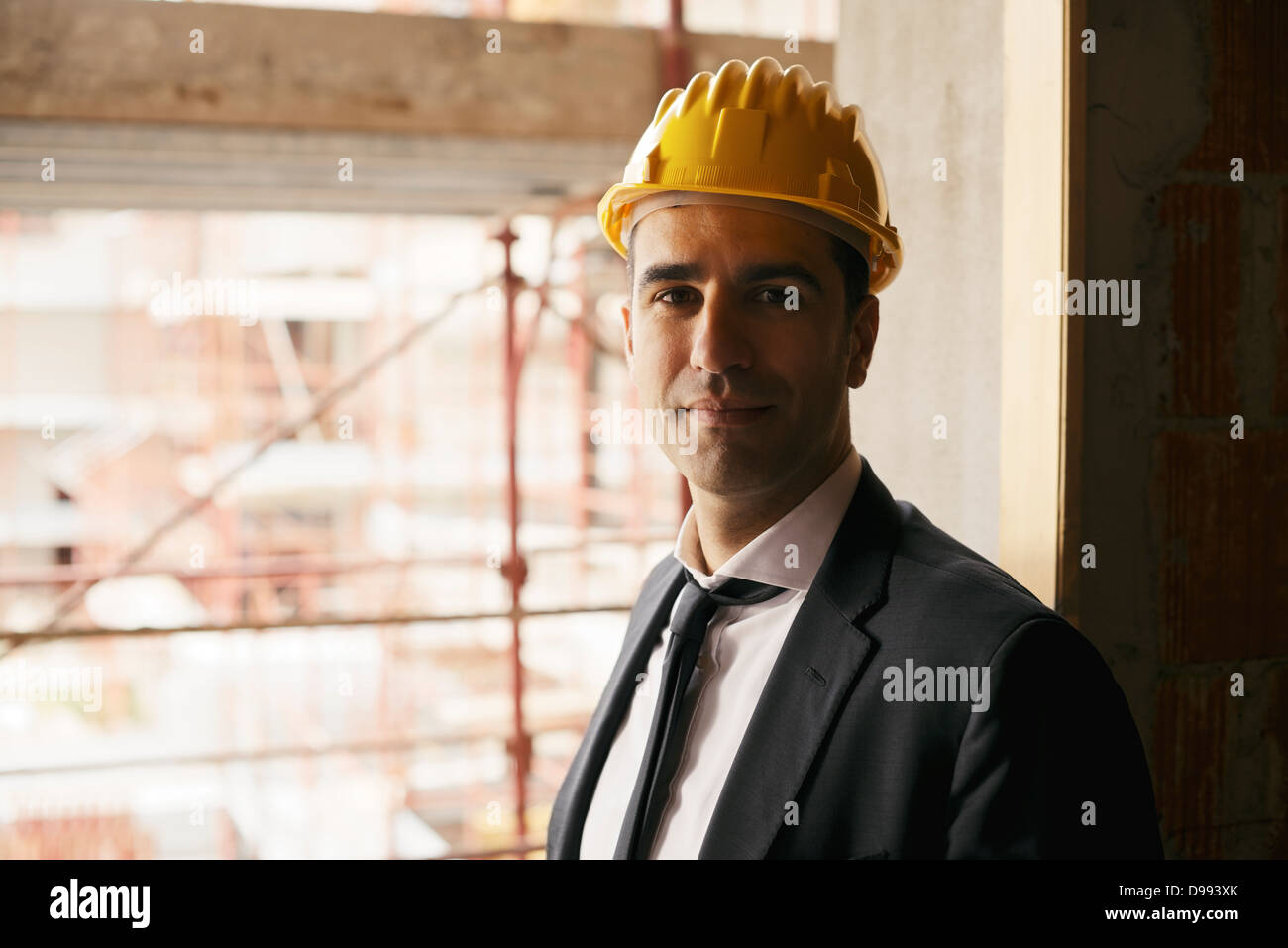 portrait of male engineer smiling and looking at camera in construction ...